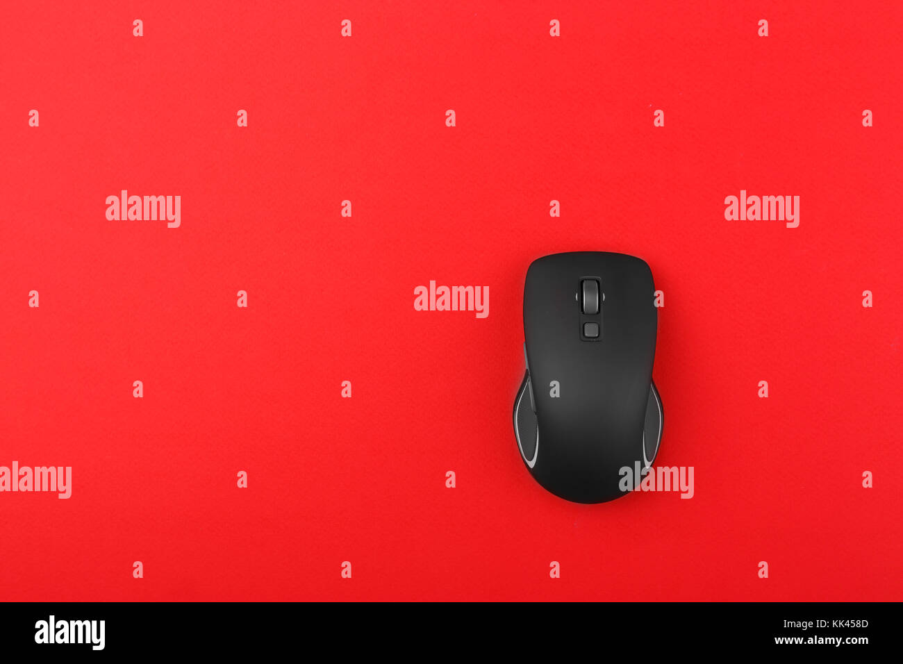 black computer wireless mouse on a red background, top view Stock Photo ...