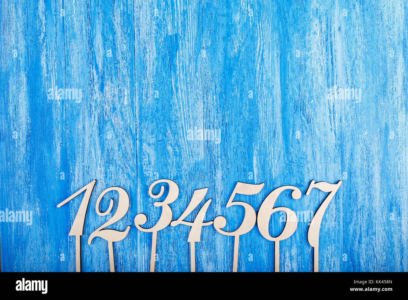 wooden numbers one, two, three, four, five, six, seven, scattered on a ...