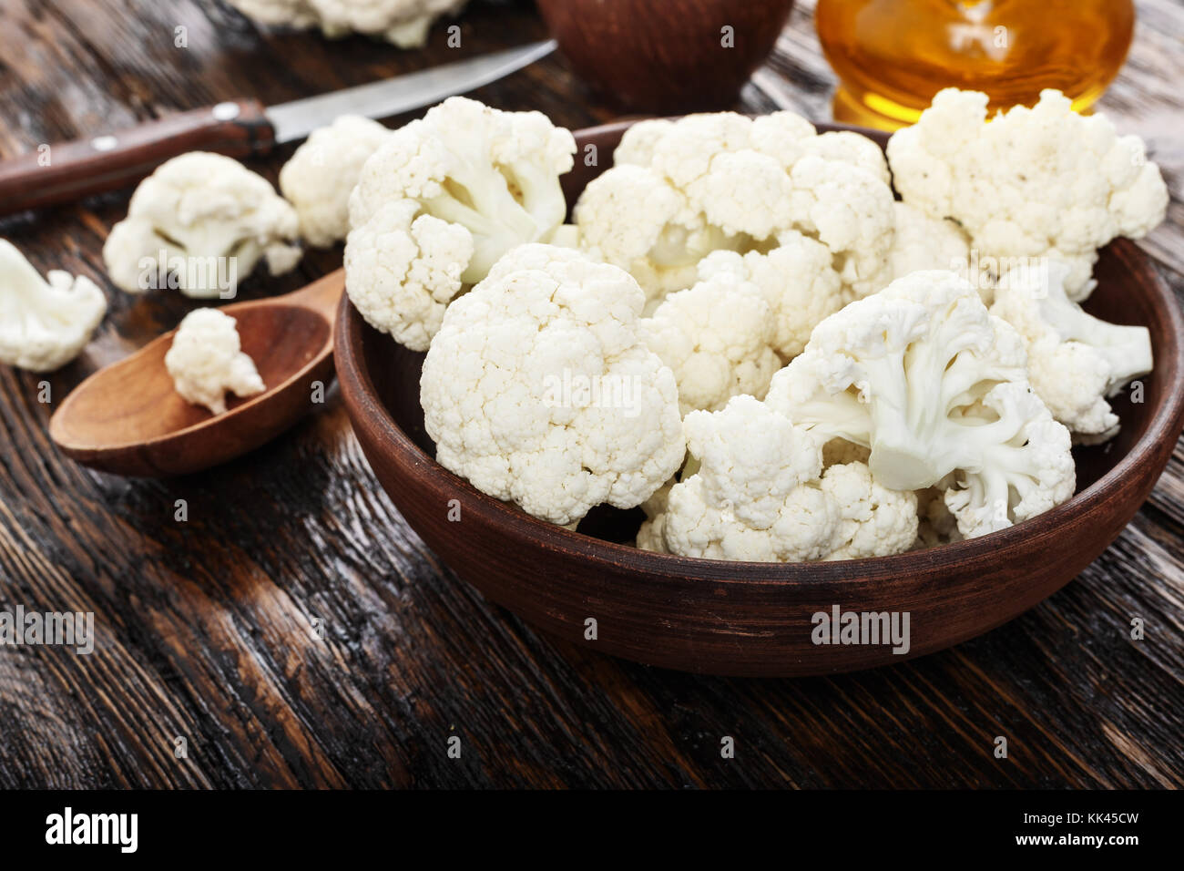 Useful cauliflower in a clay plate on a wooden table in the kitchen ...
