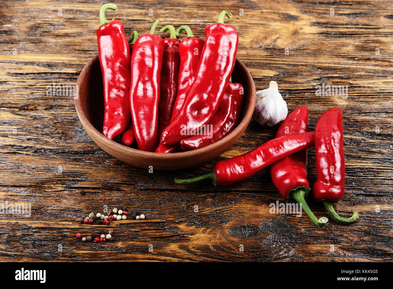 red pepper in a clay plate on dark wooden surface Stock Photo - Alamy