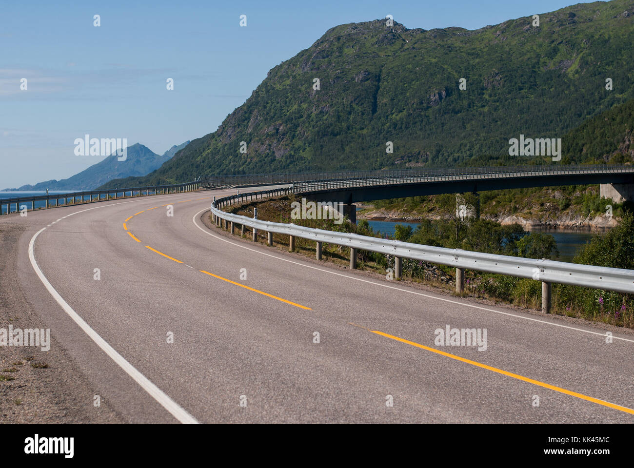A steep curve of the road against the backdrop of mountains Stock Photo ...