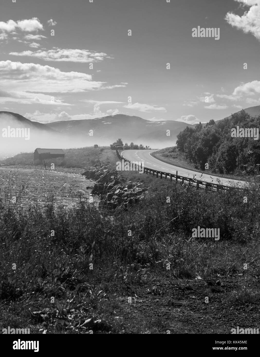 A steep curve of the road against the backdrop of mountains Stock Photo ...