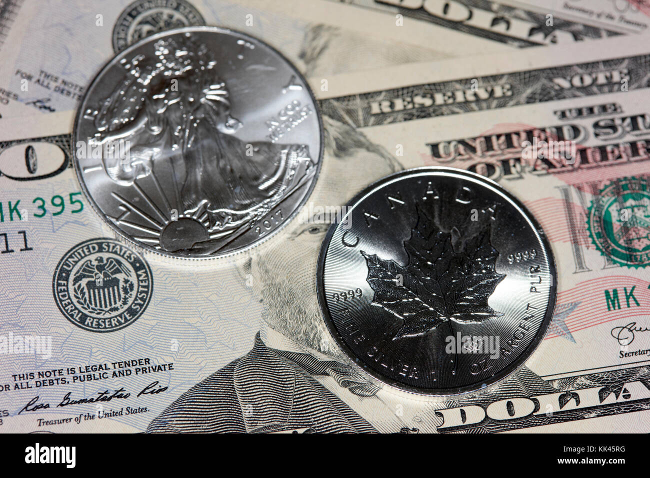 1oz silver bullion coins with us dollars cash banknotes Stock Photo - Alamy
