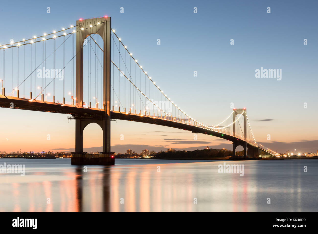 The Bronx-Whitestone Bridge reflecting on the East River at night in ...