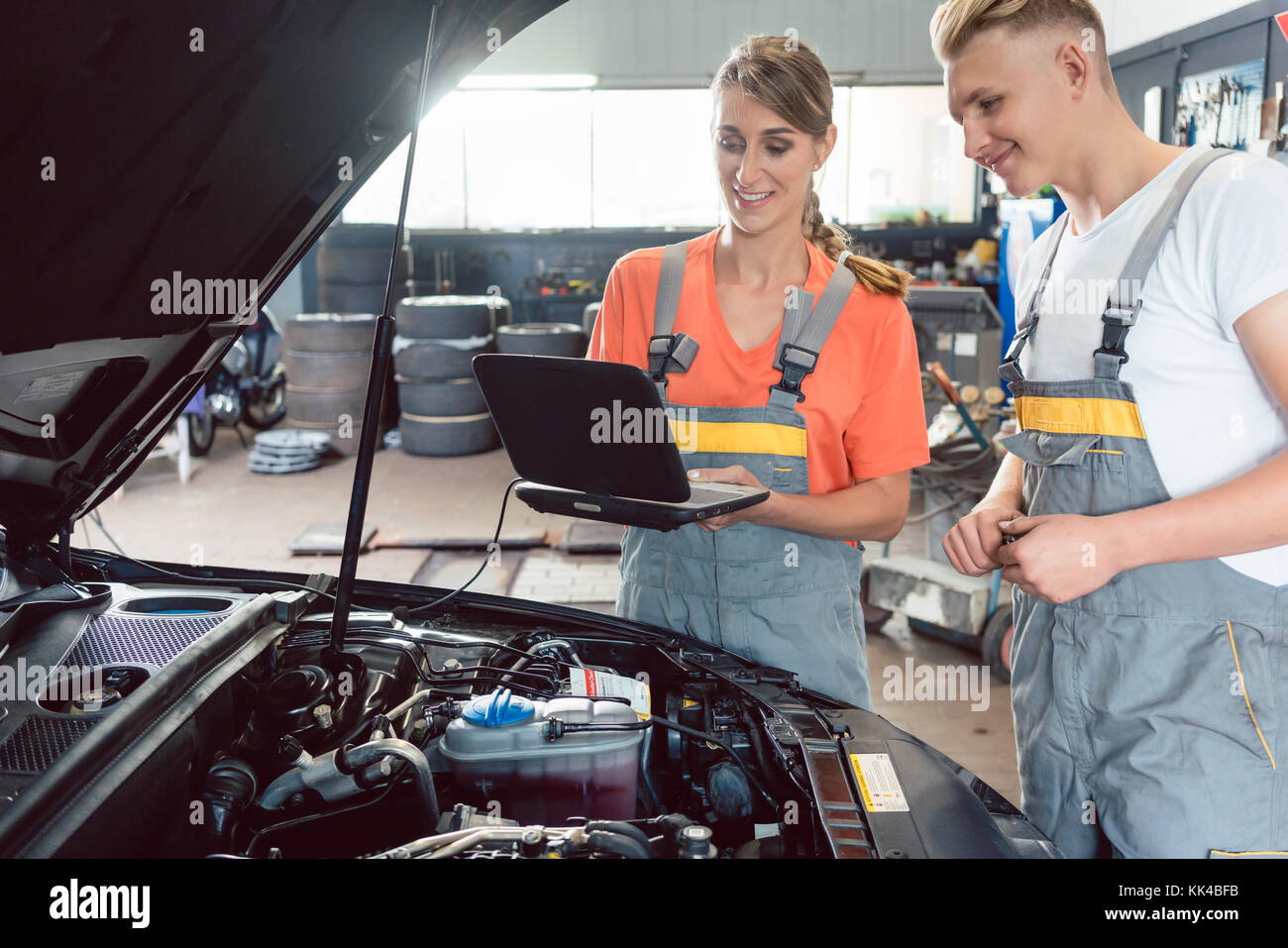 Experienced female auto mechanic checking the engine error codes Stock ...