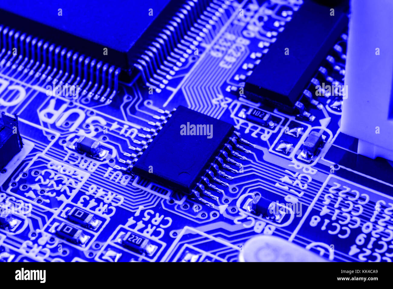 Integrated semiconductor microchip on blue circuit board representative ...