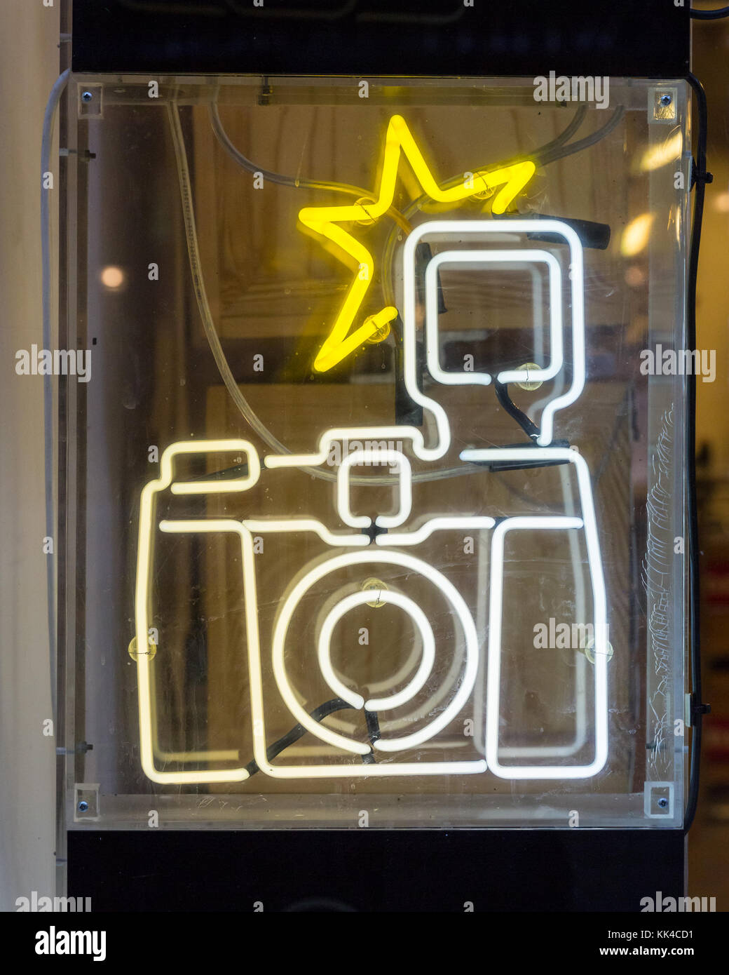 Neon lights depicting a flashlight and photography camera taking an ...