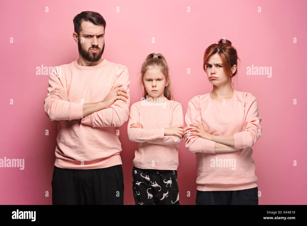 The sad family on pink Stock Photo - Alamy