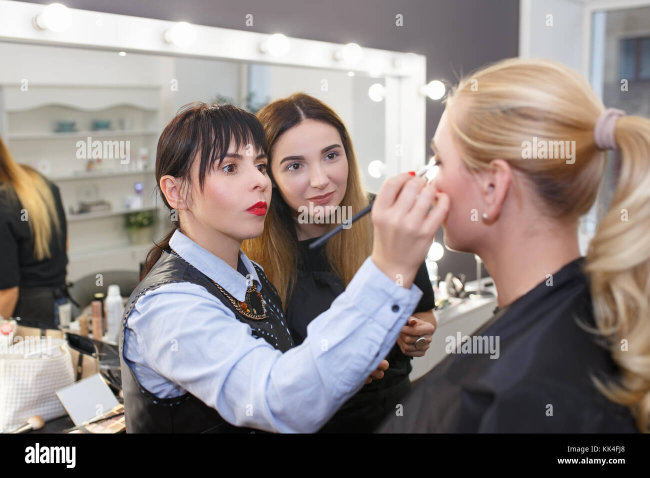 makeup teacher with her student girl. Makeup tutorial lesson at beauty ...
