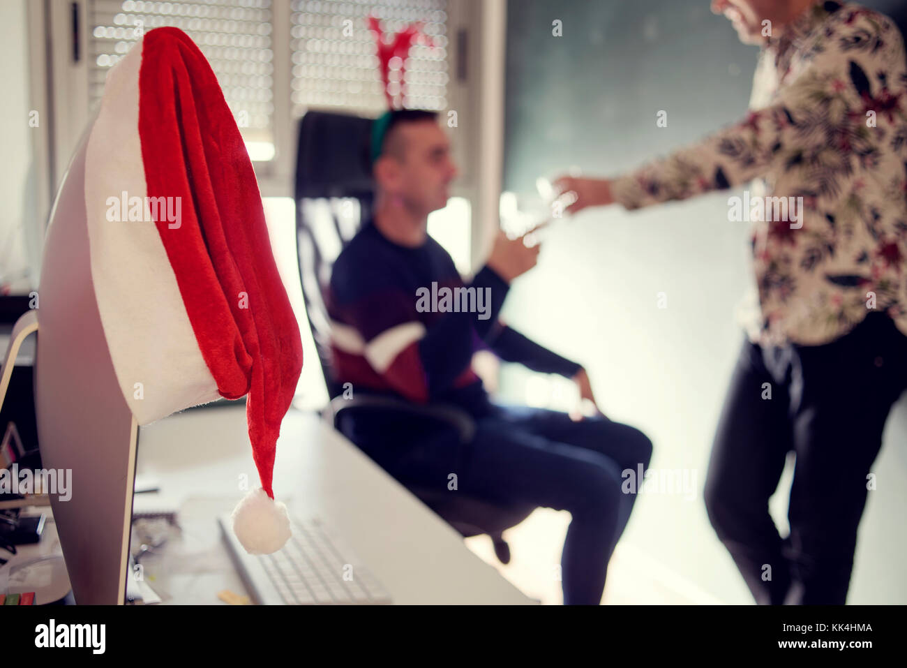 two young caucasian men chinking their glasses in the celebration of an ...