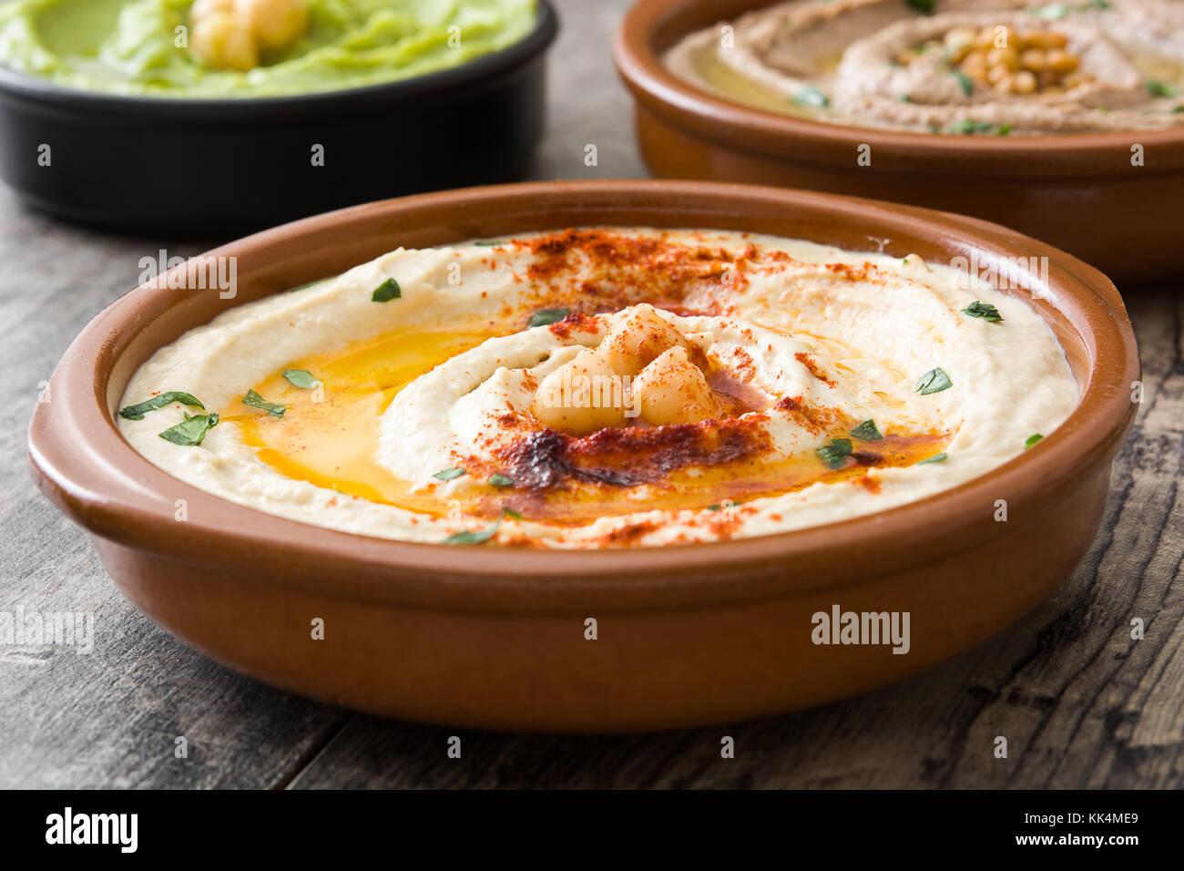 Different hummus bowls. Chickpea hummus, avocado hummus and lentils ...