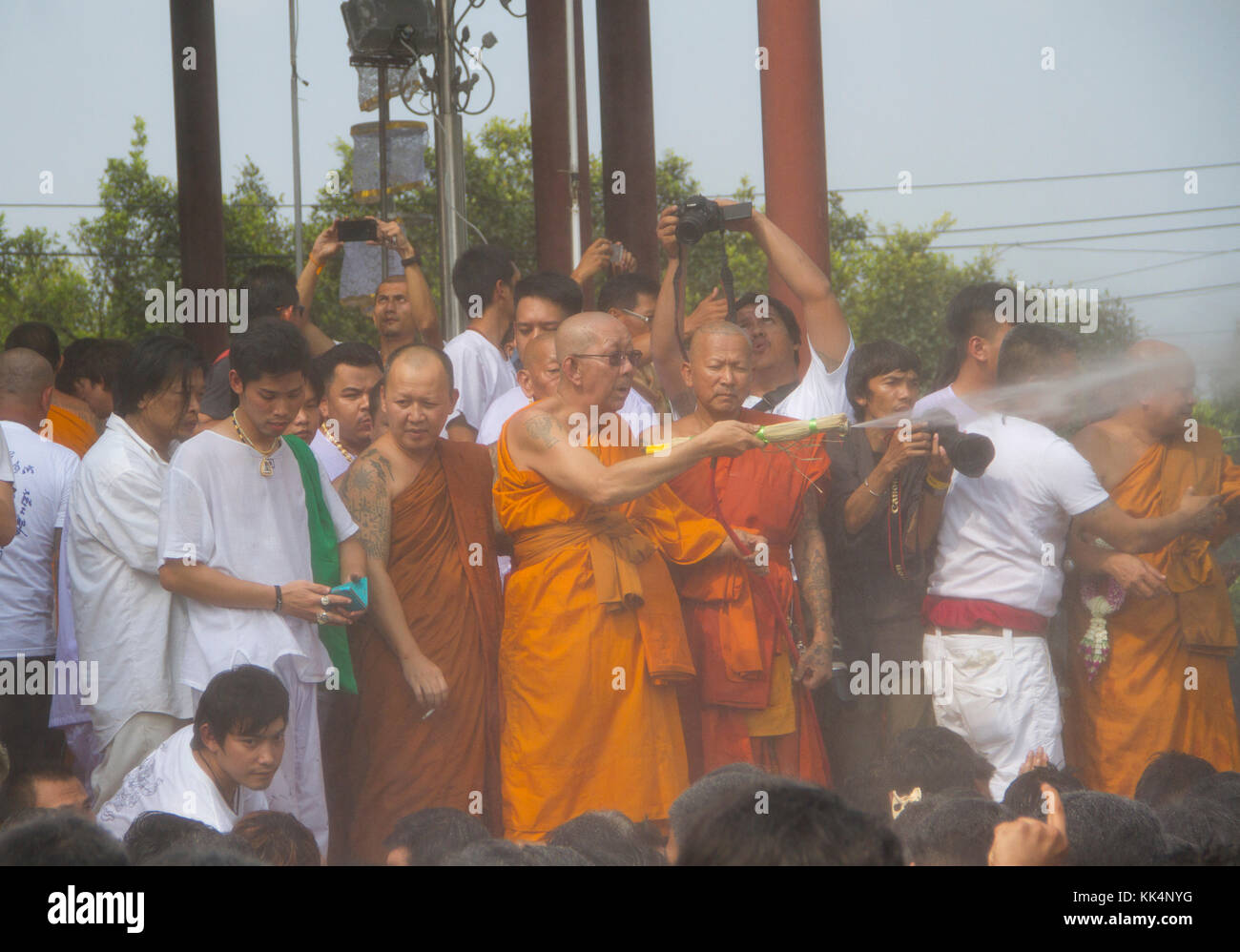 Buddhist monks spray water on the crowd at the Wat Bang Phra Temple for ...