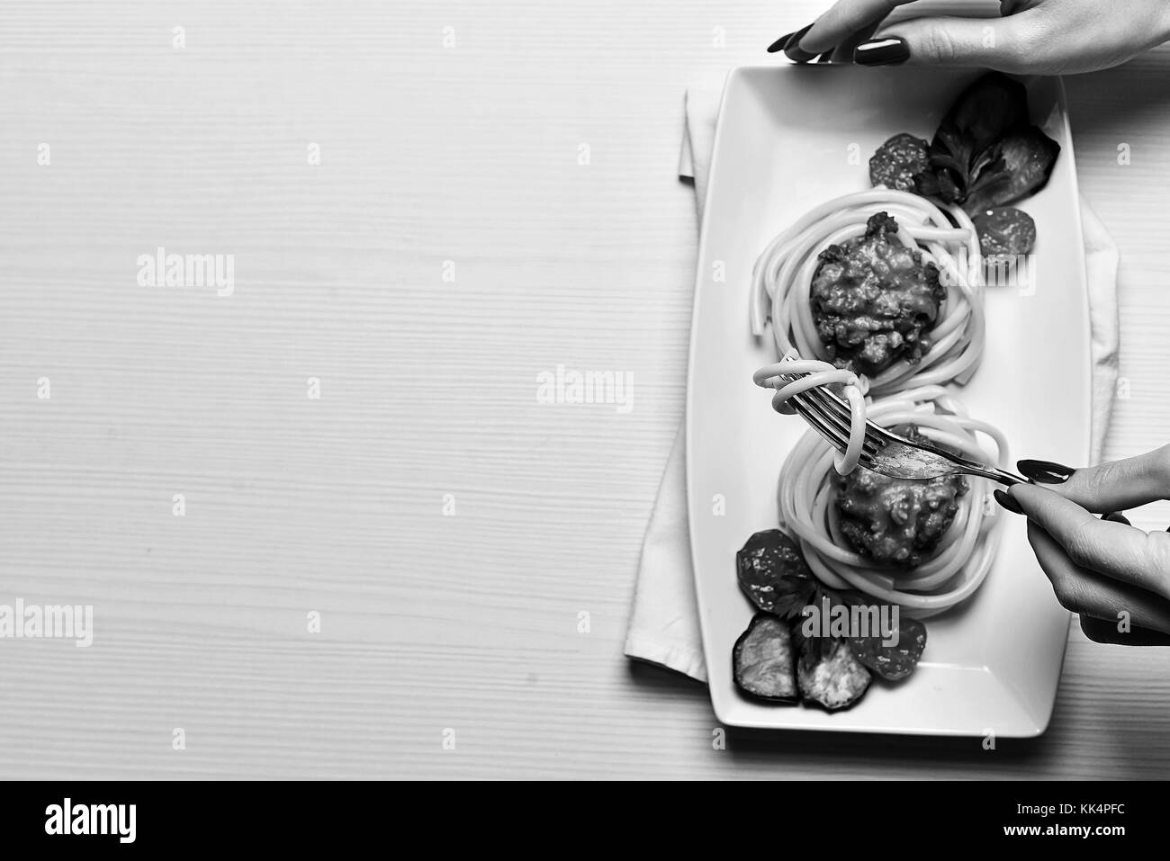 Dinner in the restaurant. Hands plates of food. Fork for eating Stock ...