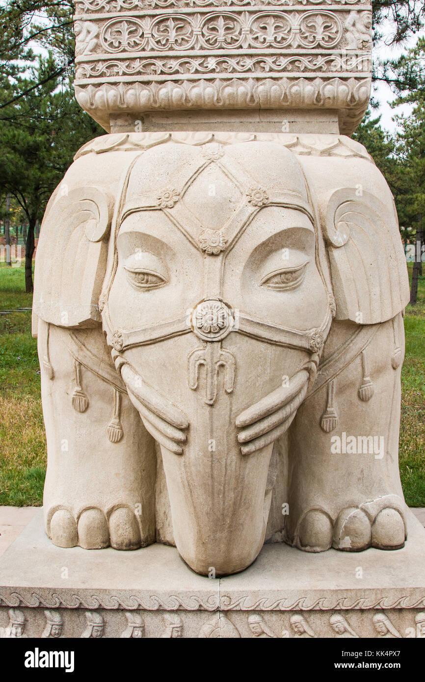 An elephant carved into the bottom of a stone pillar Stock Photo - Alamy