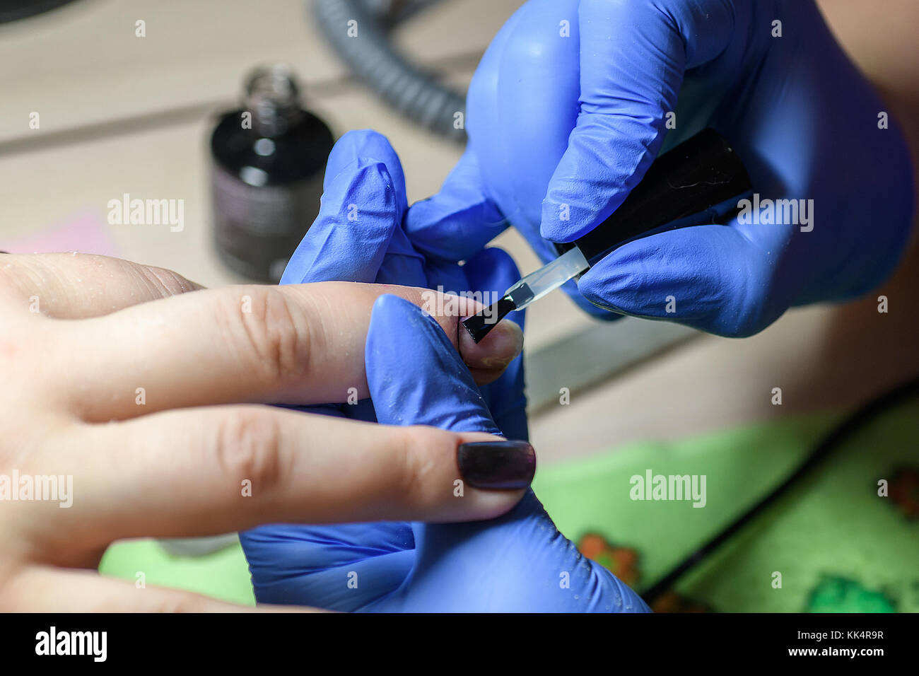 Manicure. Master does manicure on nails paint hand Stock Photo - Alamy