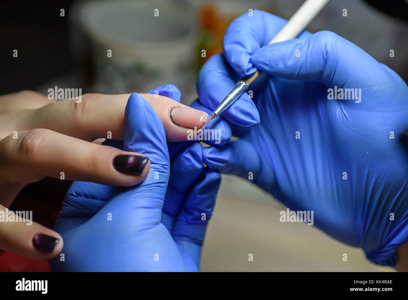 Manicure. Master does manicure on nails paint hand Stock Photo - Alamy