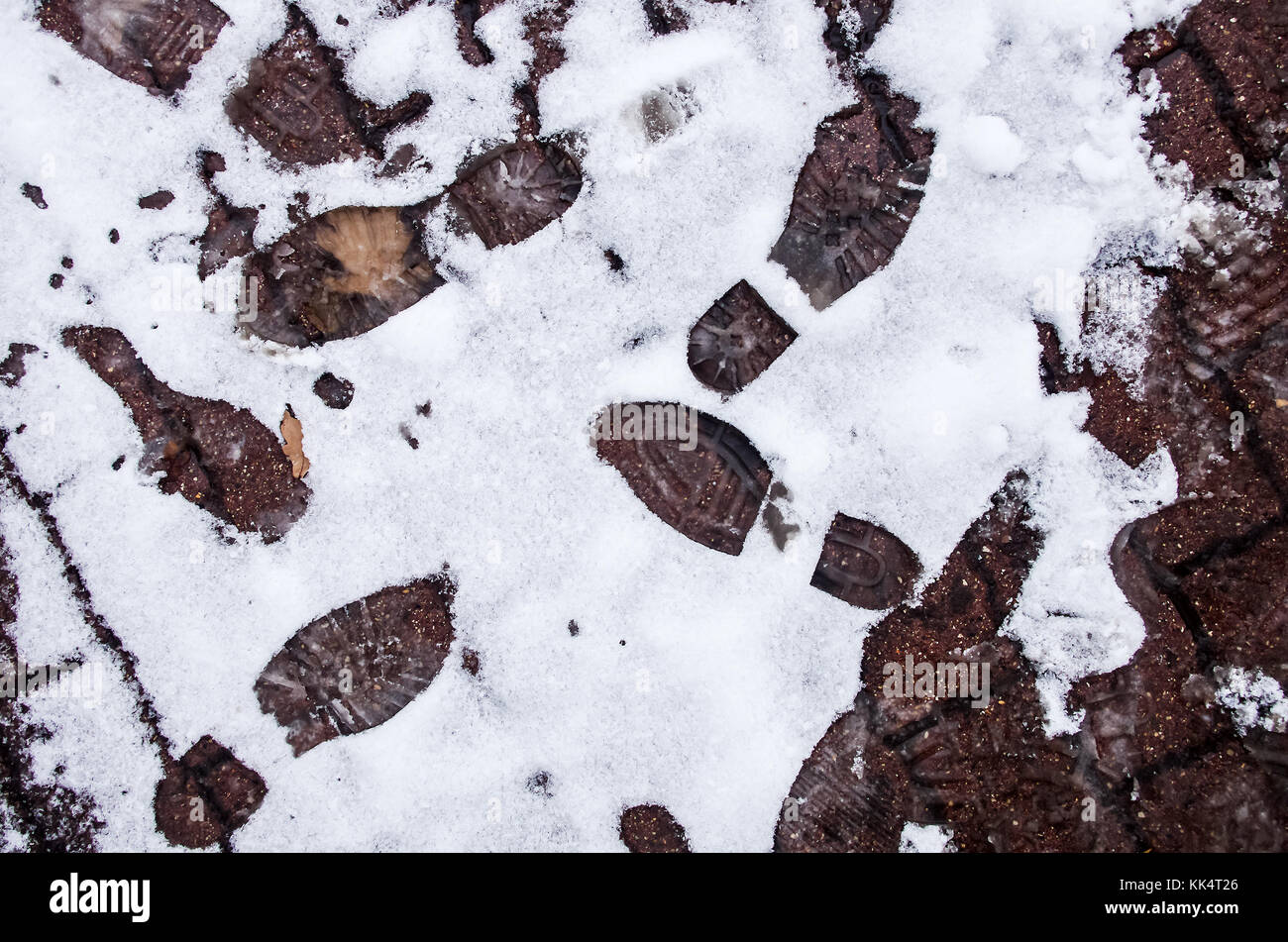 Dirty footprints in the snow winter. Track from boots on the tra Stock ...