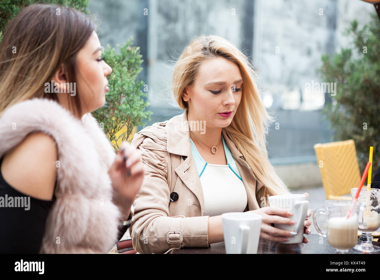 Female girl friends in the city relaxing Stock Photo - Alamy