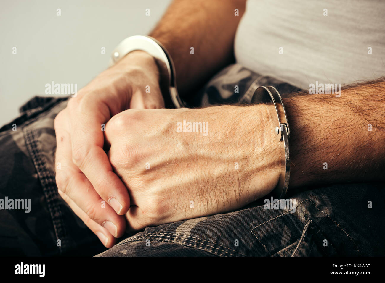 Handcuffed soldier in military army clothes. Prisoner of war or ...