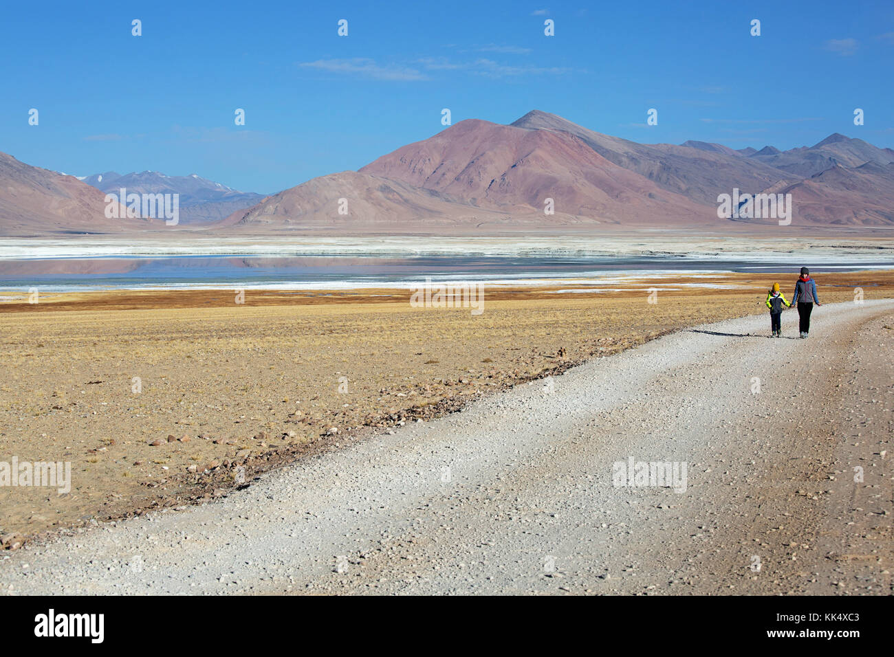 Mother and son on a morning stroll on a desert road at Tso Kar, Ladakh ...