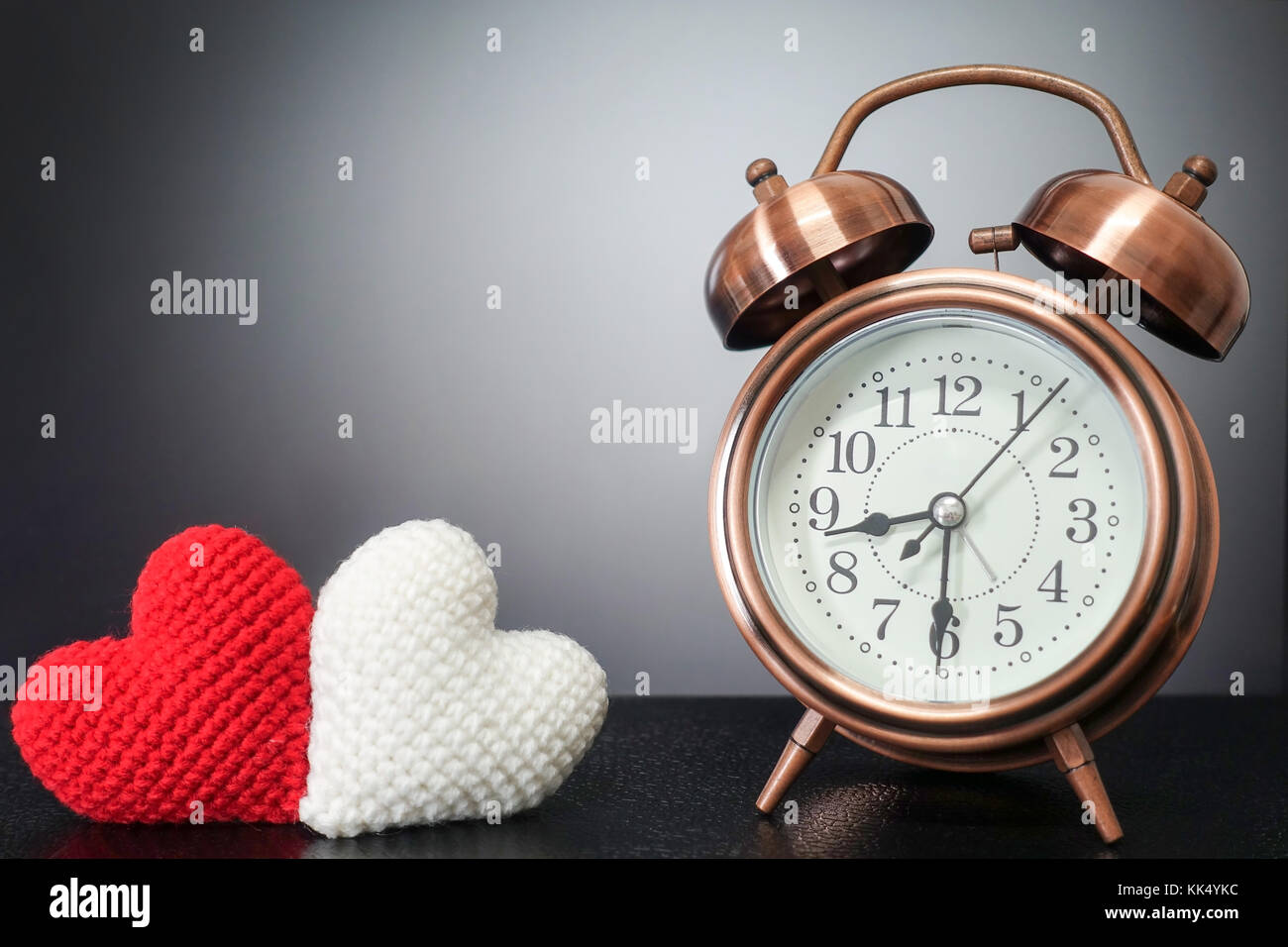 retro clock with love heart yarn on black background - love with time ...