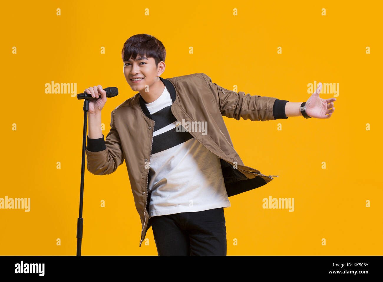 Standing performance microphone arts culture and entertainment smiling hi-res stock photography ...