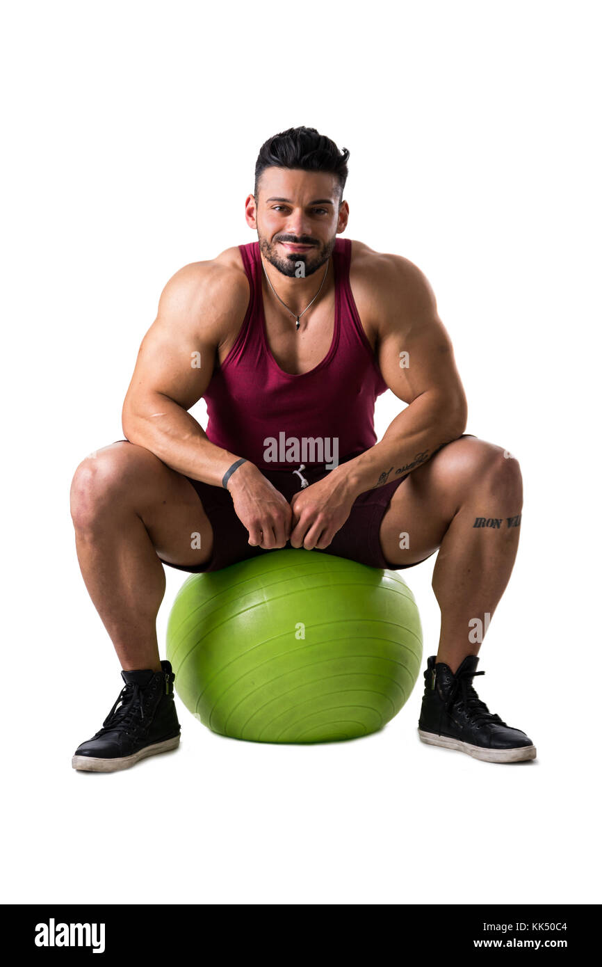 Muscular man holding inflatable fitness ball, looking at camera ...