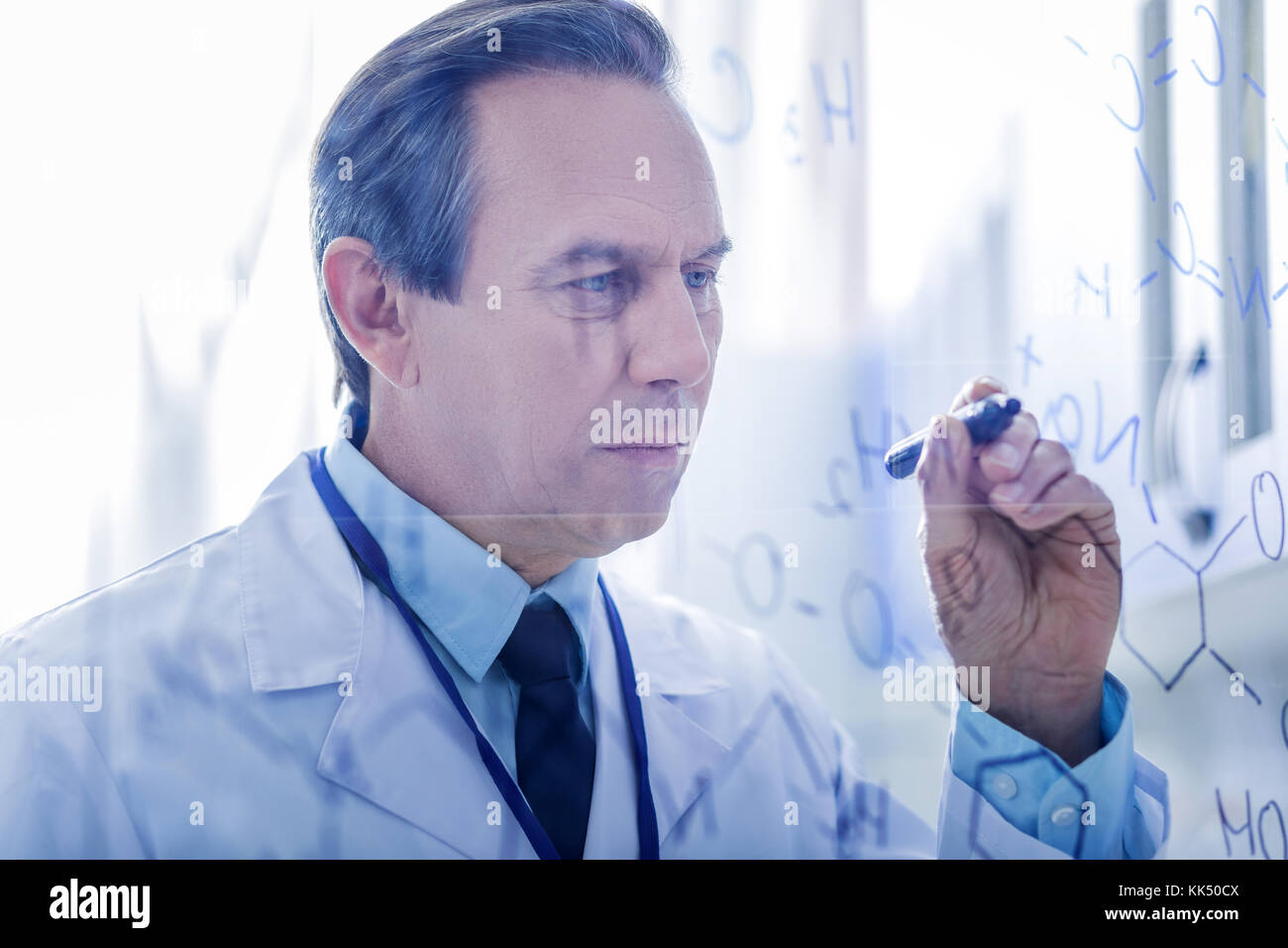 Serious handsome man working with formulas Stock Photo - Alamy