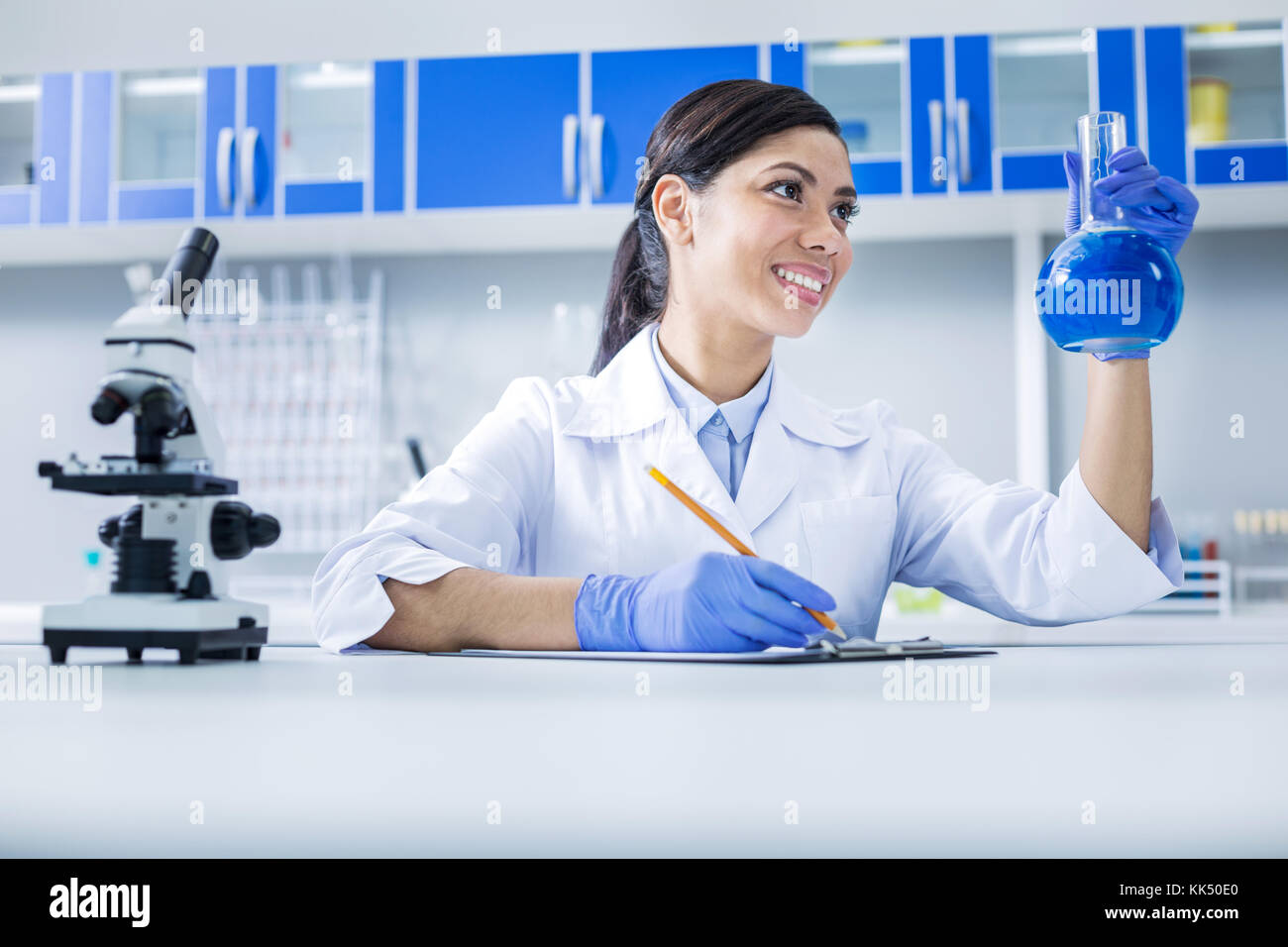 Nice delighted woman taking notes Stock Photo - Alamy