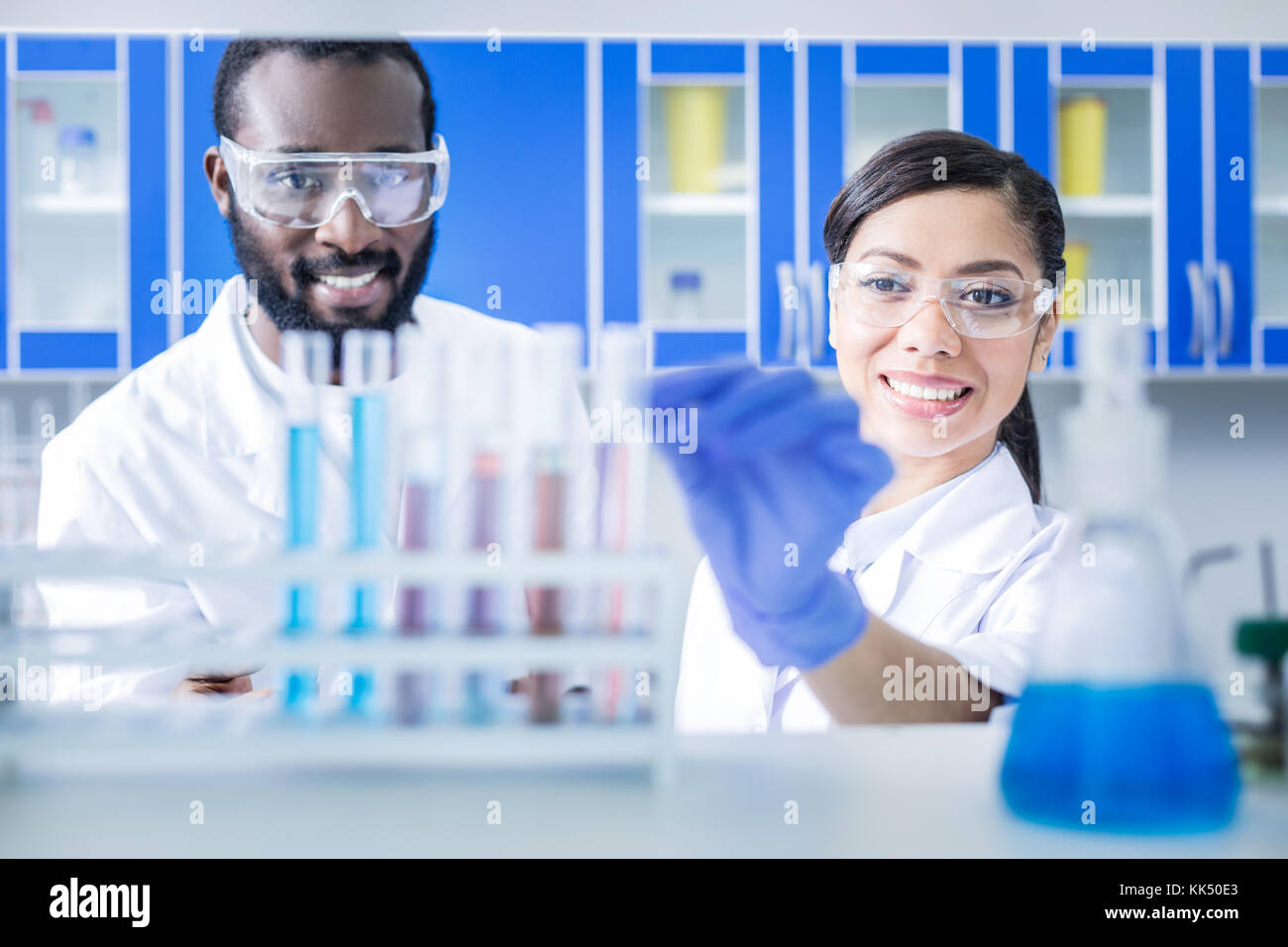 Joyful nice scientists wearing protective glasses Stock Photo - Alamy