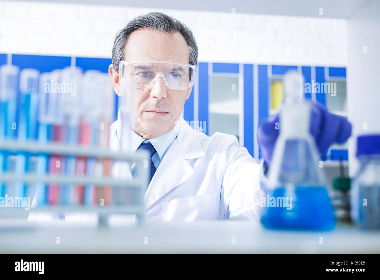 Serious skillful scientist focusing on work Stock Photo - Alamy