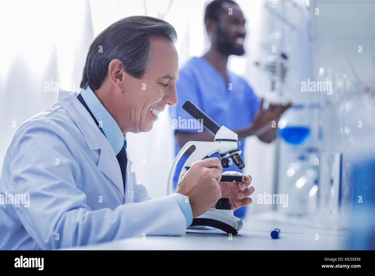 Cheerful professional biologist smiling Stock Photo - Alamy