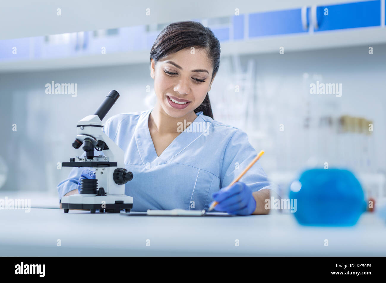 Serious nice woman noting down her observations Stock Photo - Alamy