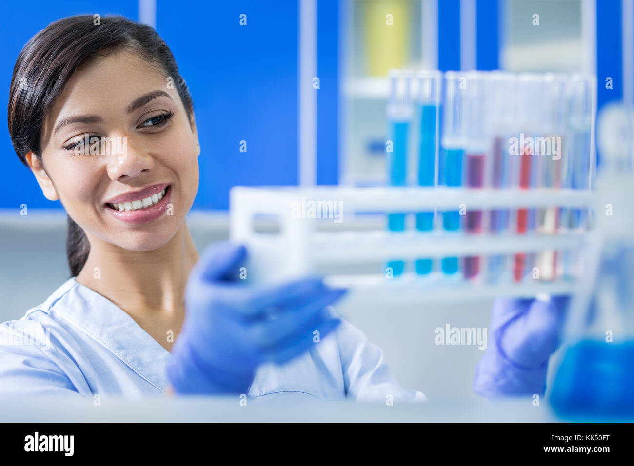 Happy delighted woman holding test tube rack Stock Photo - Alamy