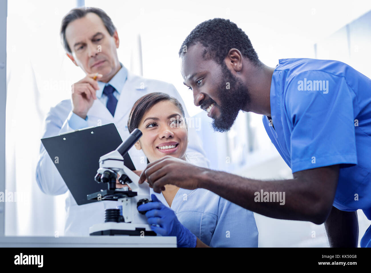 Happy delighted man leaning forward Stock Photo - Alamy