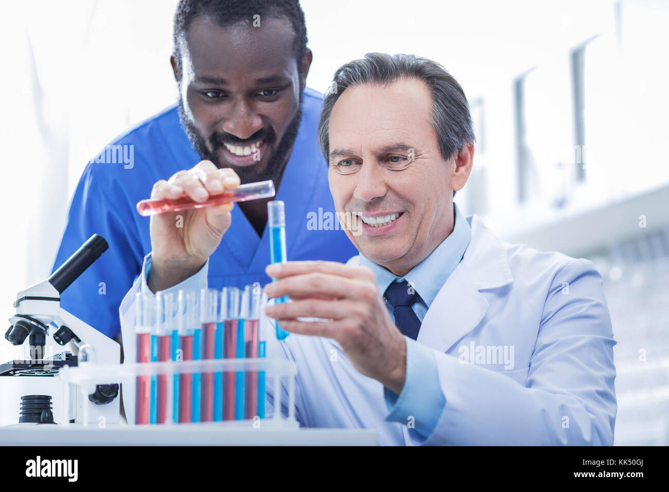 Cheerful smart doctor working with vaccines Stock Photo - Alamy