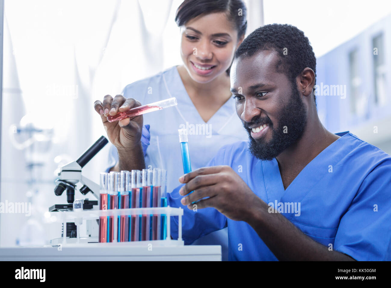 Happy positive scientist working in pair Stock Photo - Alamy