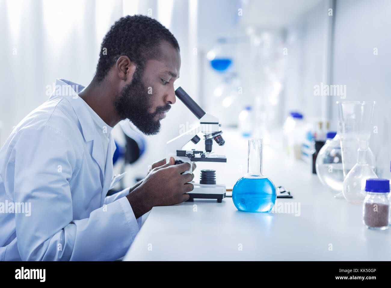 Handsome male scientist looking into the microscope Stock Photo - Alamy Handsome male scientist looking into the microscope Stock Photo - Alamy