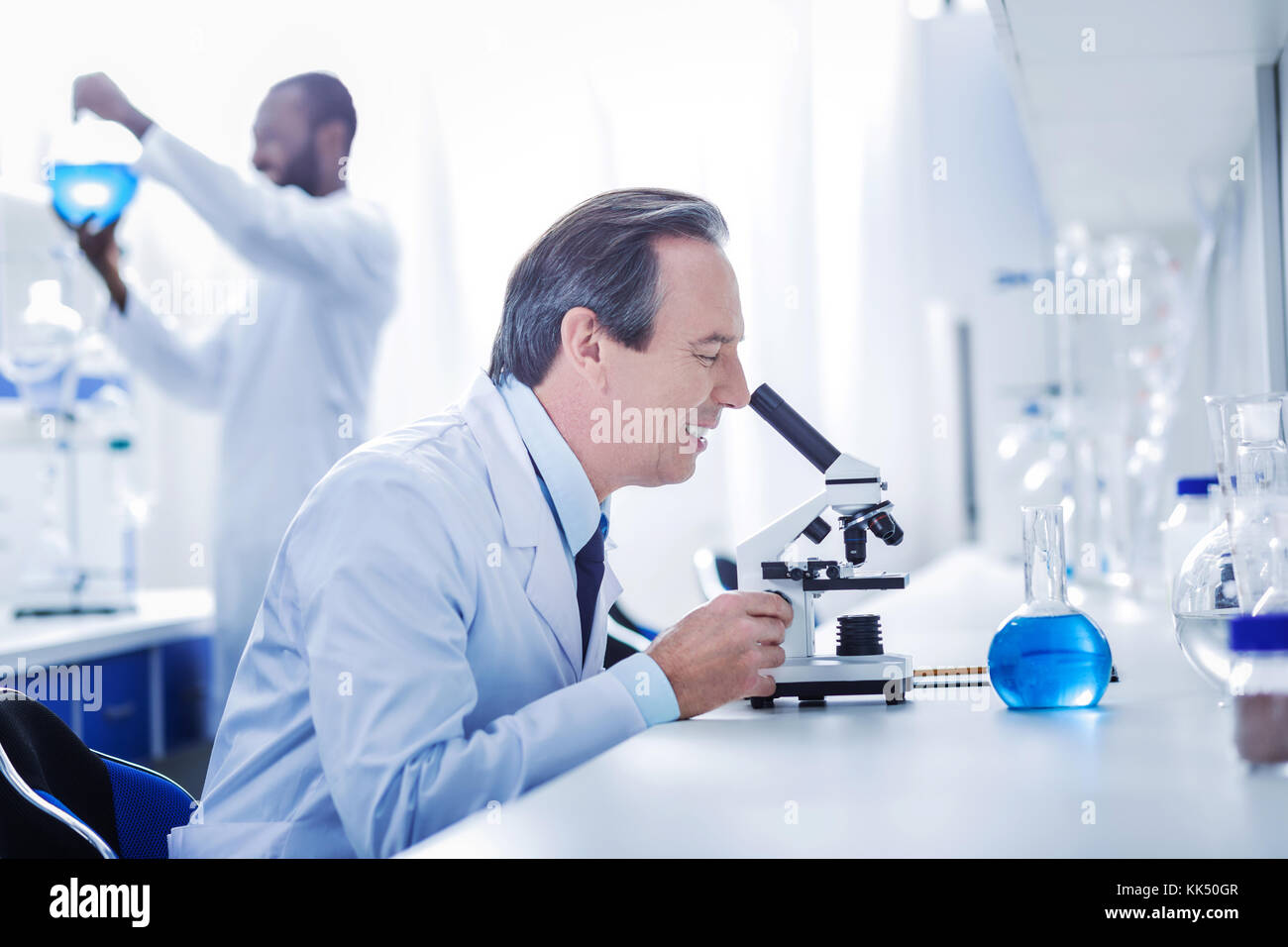 Happy nice scientist enjoying his job Stock Photo - Alamy