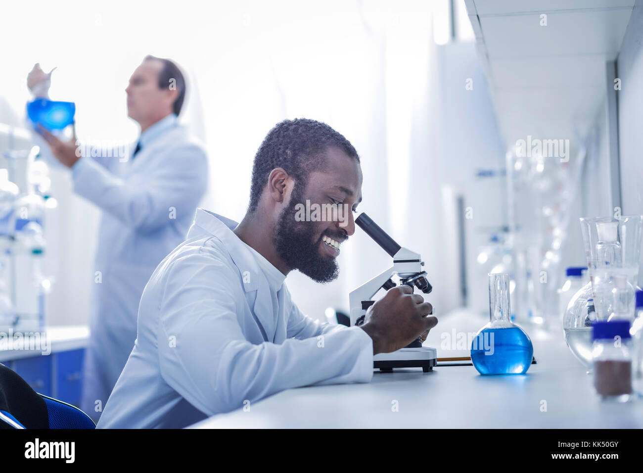 Happy smart scientist working Stock Photo - Alamy