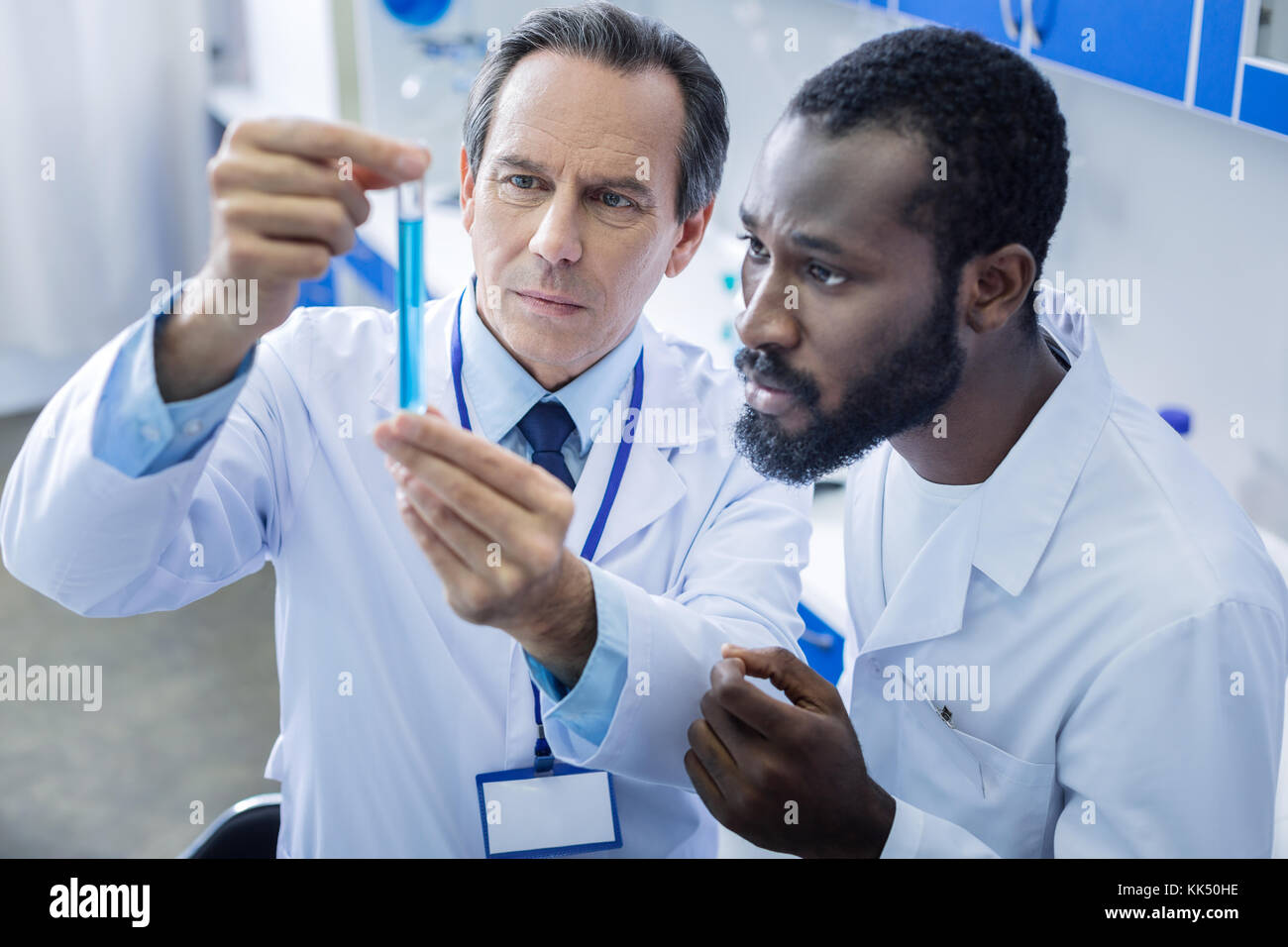 Smart serious scientist standing together Stock Photo - Alamy
