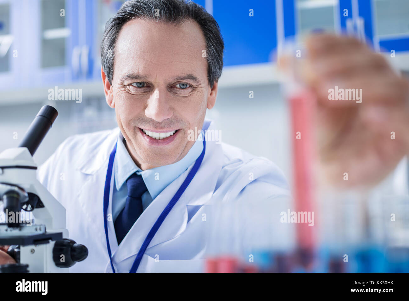 Happy delighted scientist feeling happy Stock Photo - Alamy
