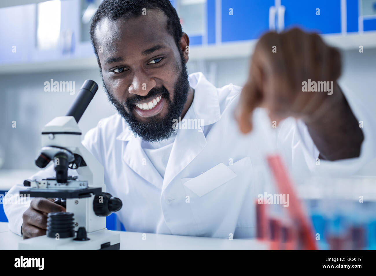 Cheerful happy scientist working with a samples Stock Photo - Alamy