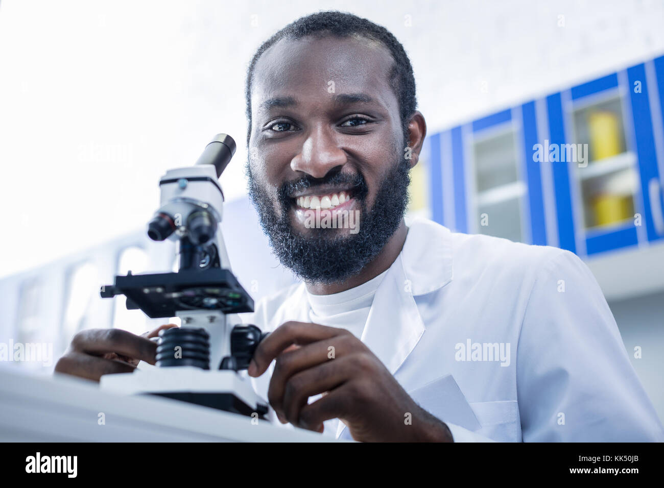 Joyful nice scientist smiling to you Stock Photo - Alamy