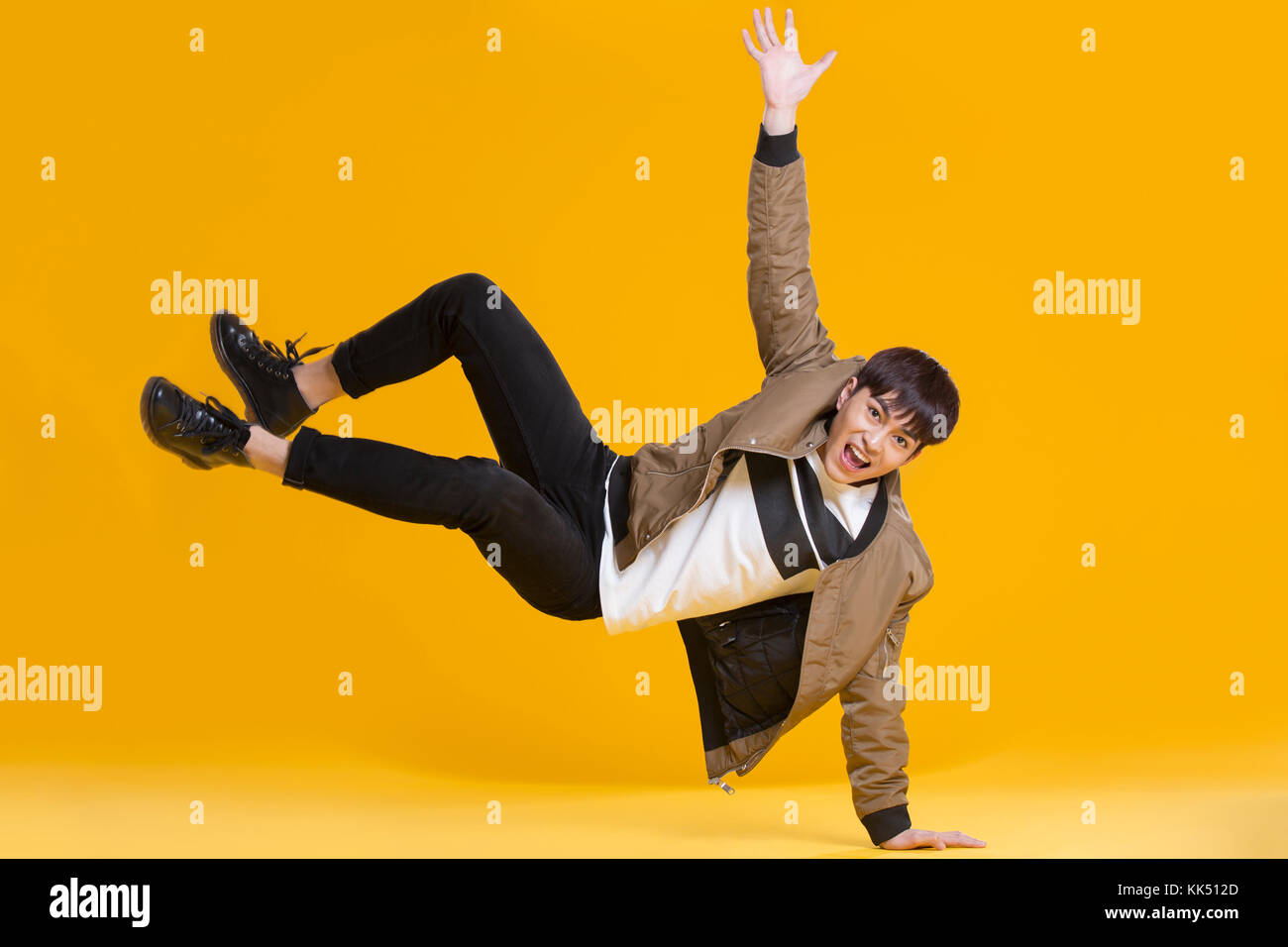 Cheerful young Chinese man dancing Stock Photo - Alamy