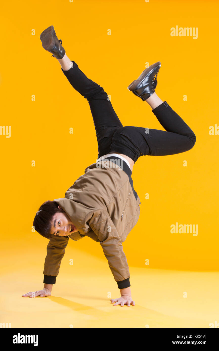 Cheerful young Chinese man dancing Stock Photo - Alamy