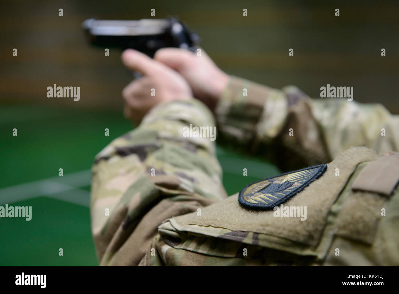 A U.S. Soldier with the 650th Military Intelligence Group fires an M9 ...