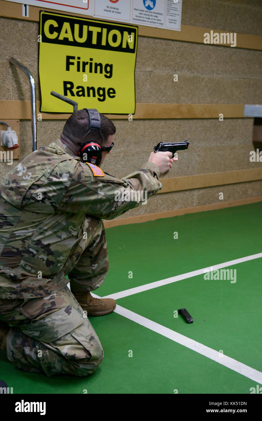 A U.S. Soldier with the 650th Military Intelligence Group fires an M9 ...