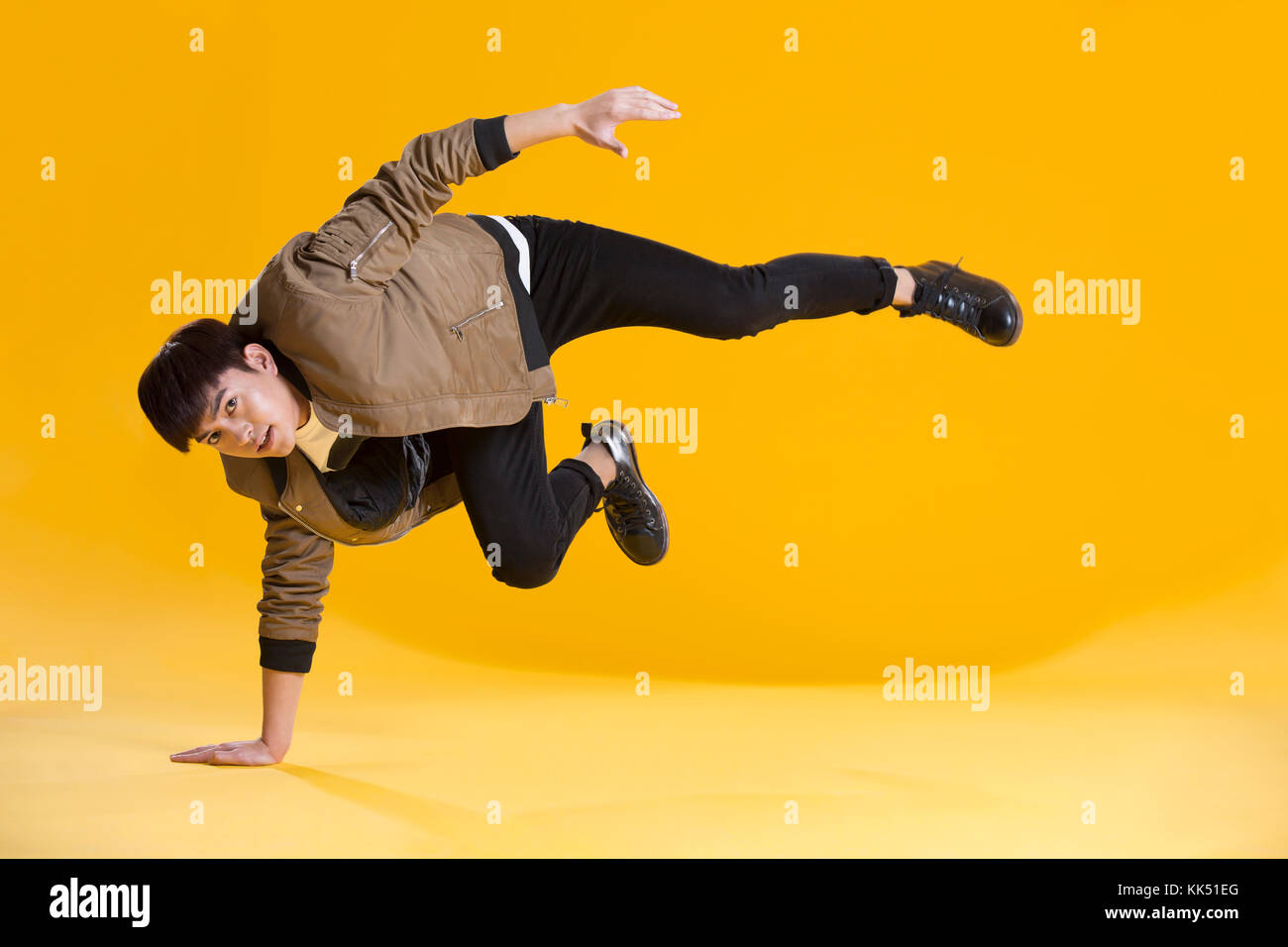Cheerful young Chinese man dancing Stock Photo - Alamy