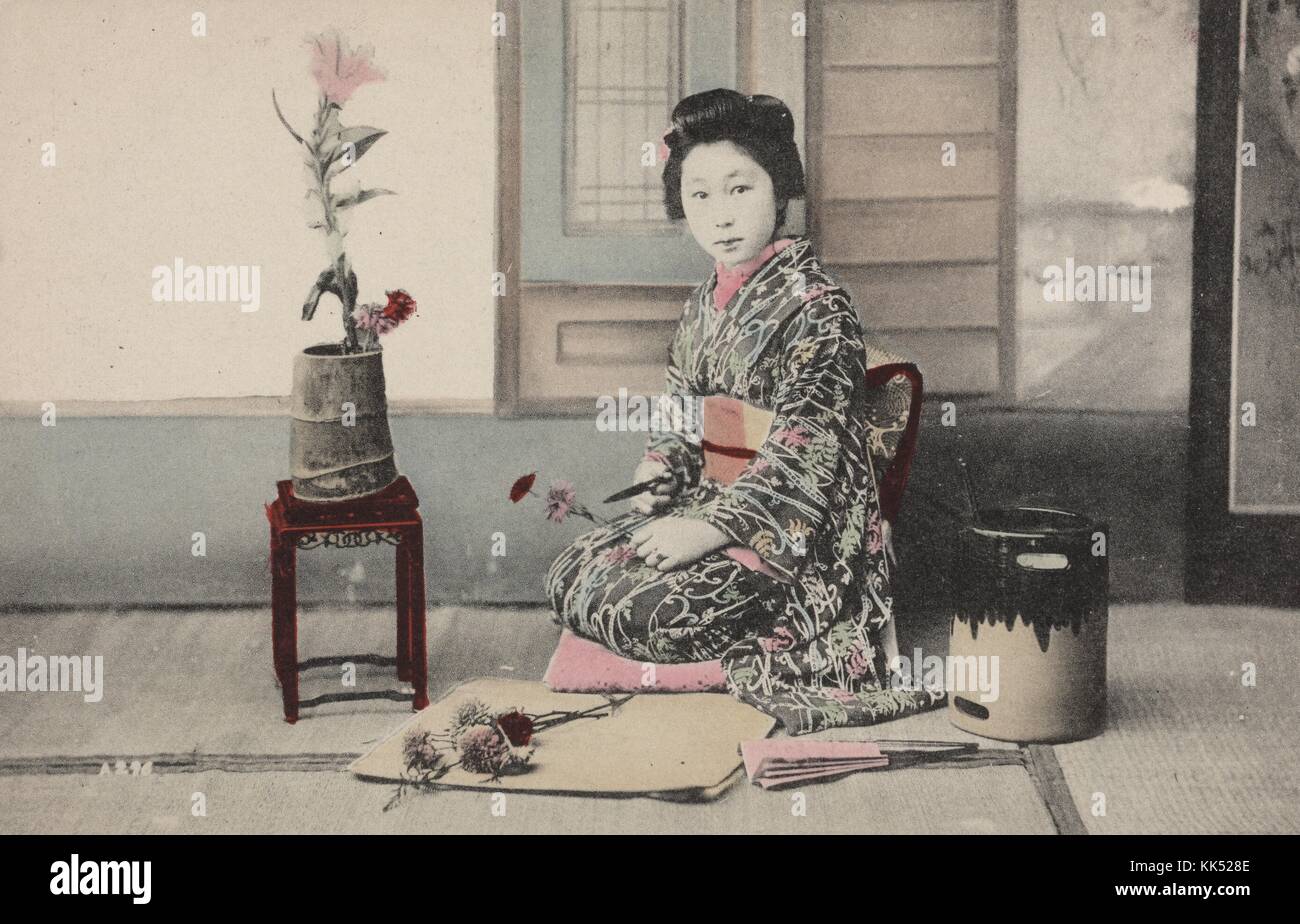 Colorized portrait of Japanese young woman, kneeling, wearing an ...